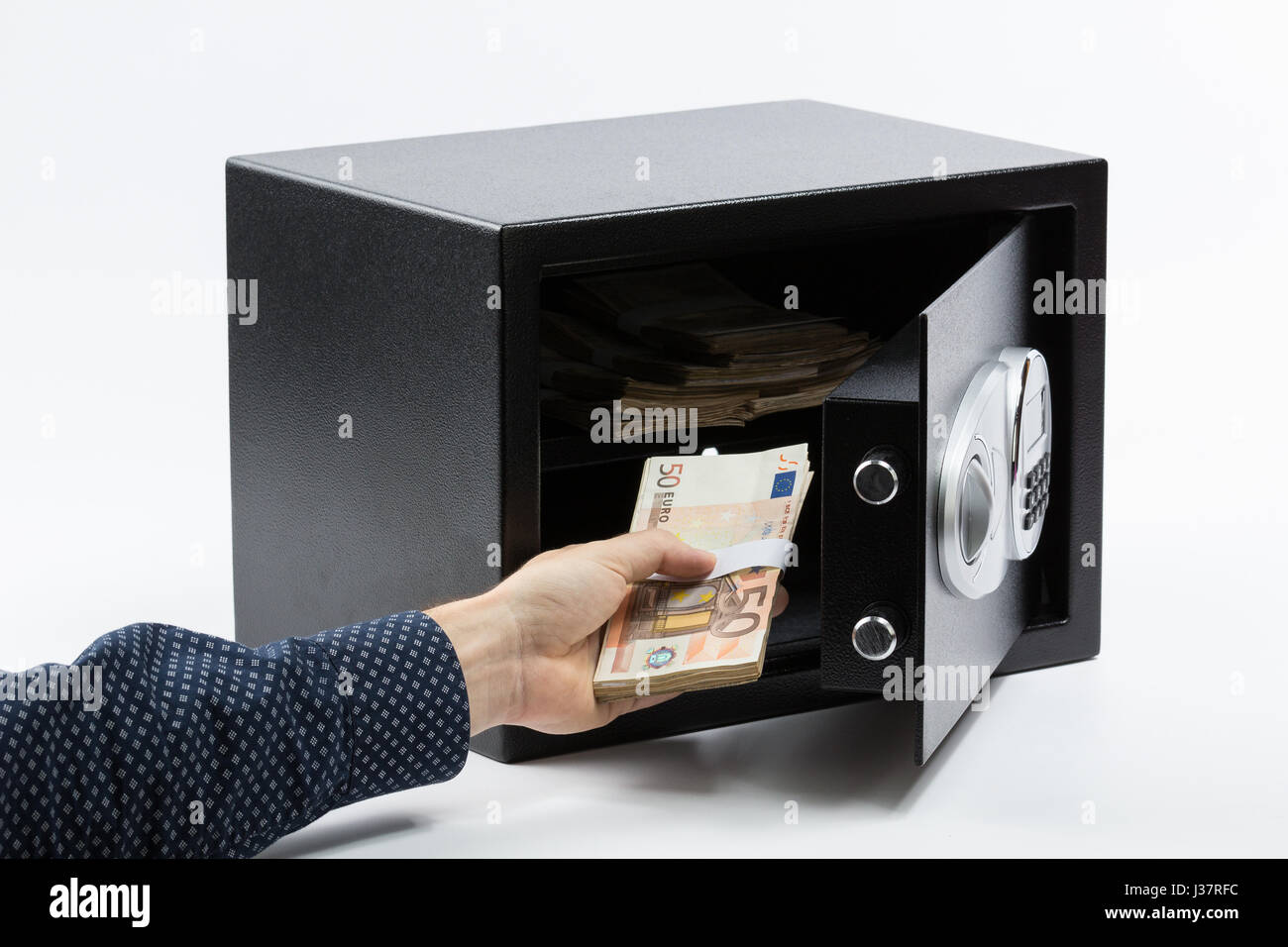 Male hand keeping euro banknotes in a safe deposit box on white ...