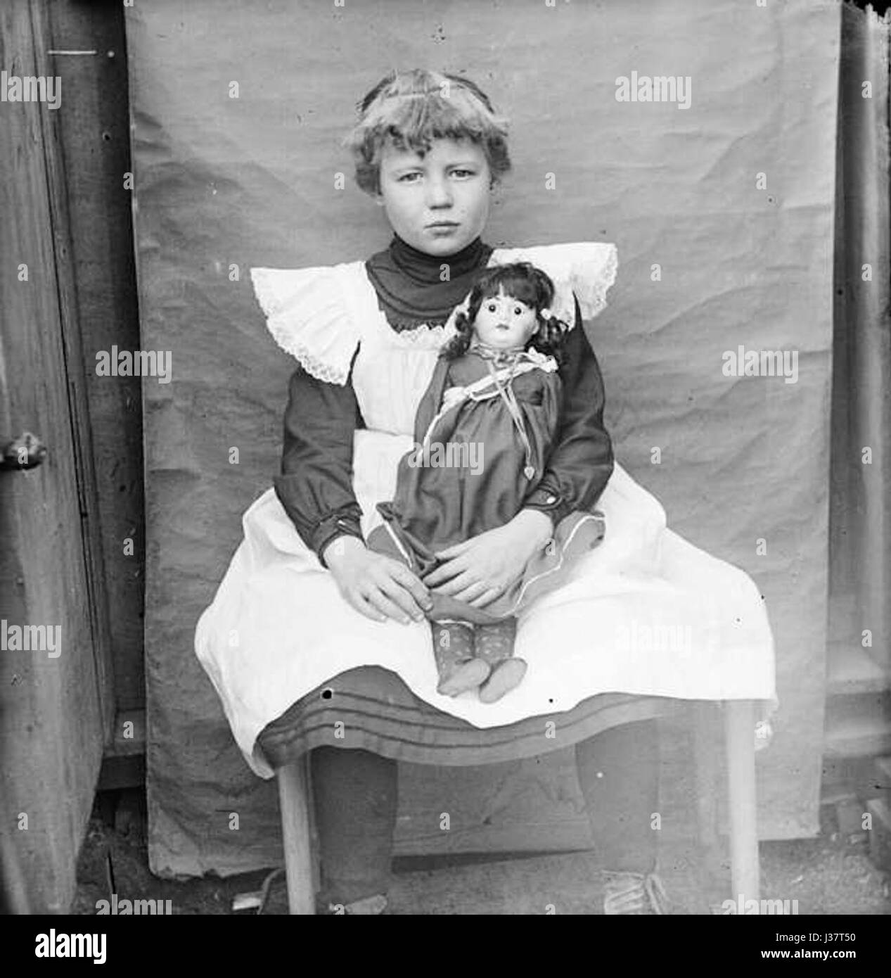 Child with doll hi-res stock photography and images - Alamy