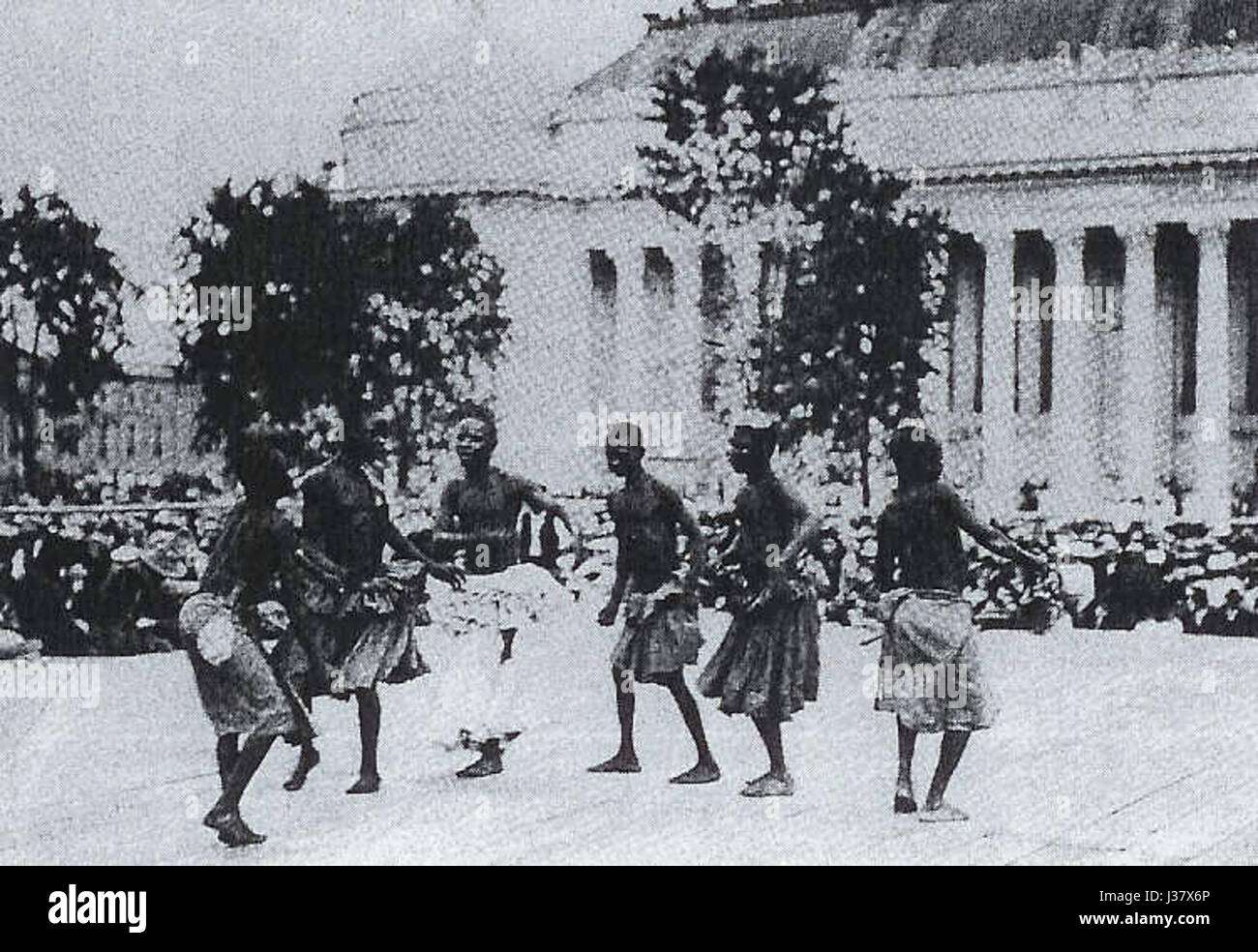 This image shows a group of pygmies engaged in a traditional dance. It ...