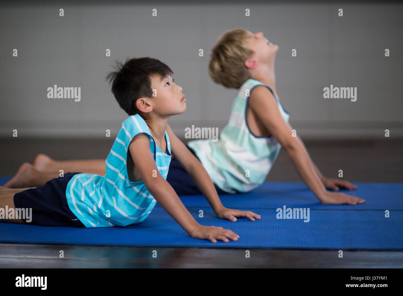 Boy performing stretching exercise hi-res stock photography and images ...