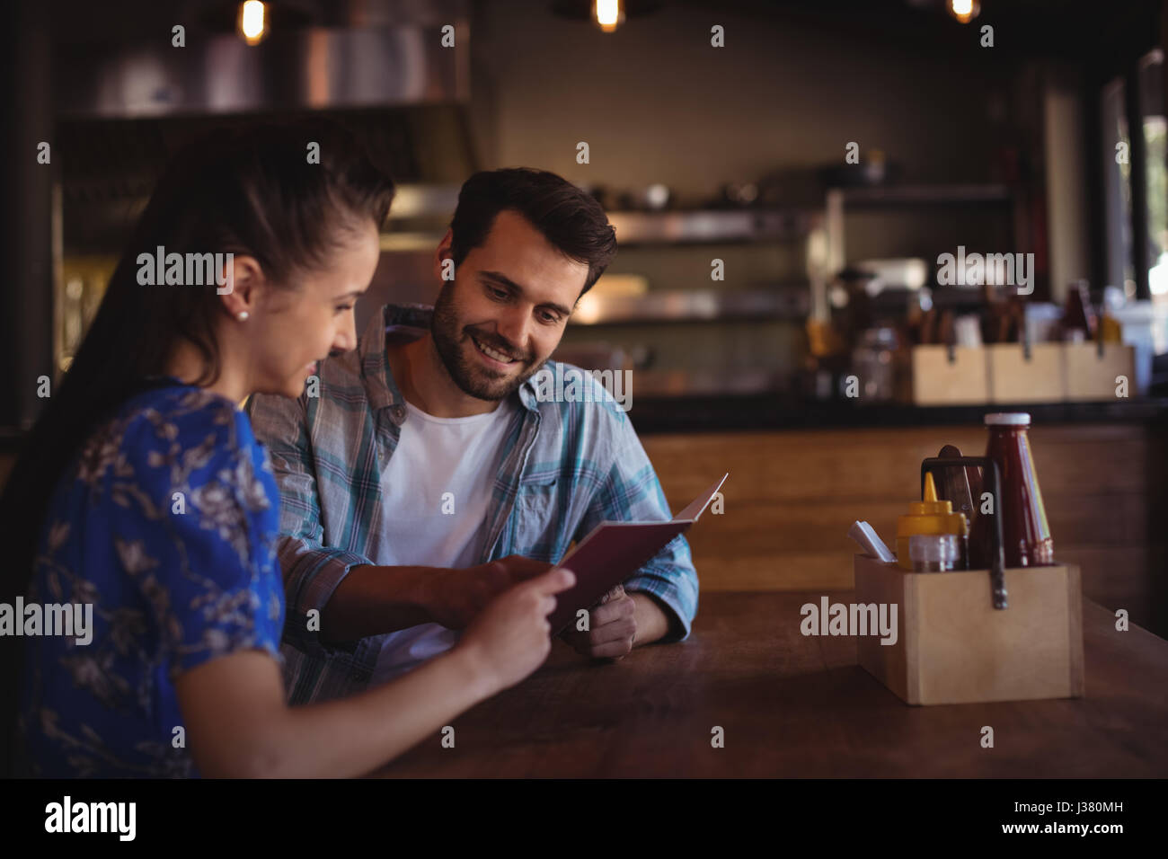 Couple looking at menu in bar Stock Photo - Alamy
