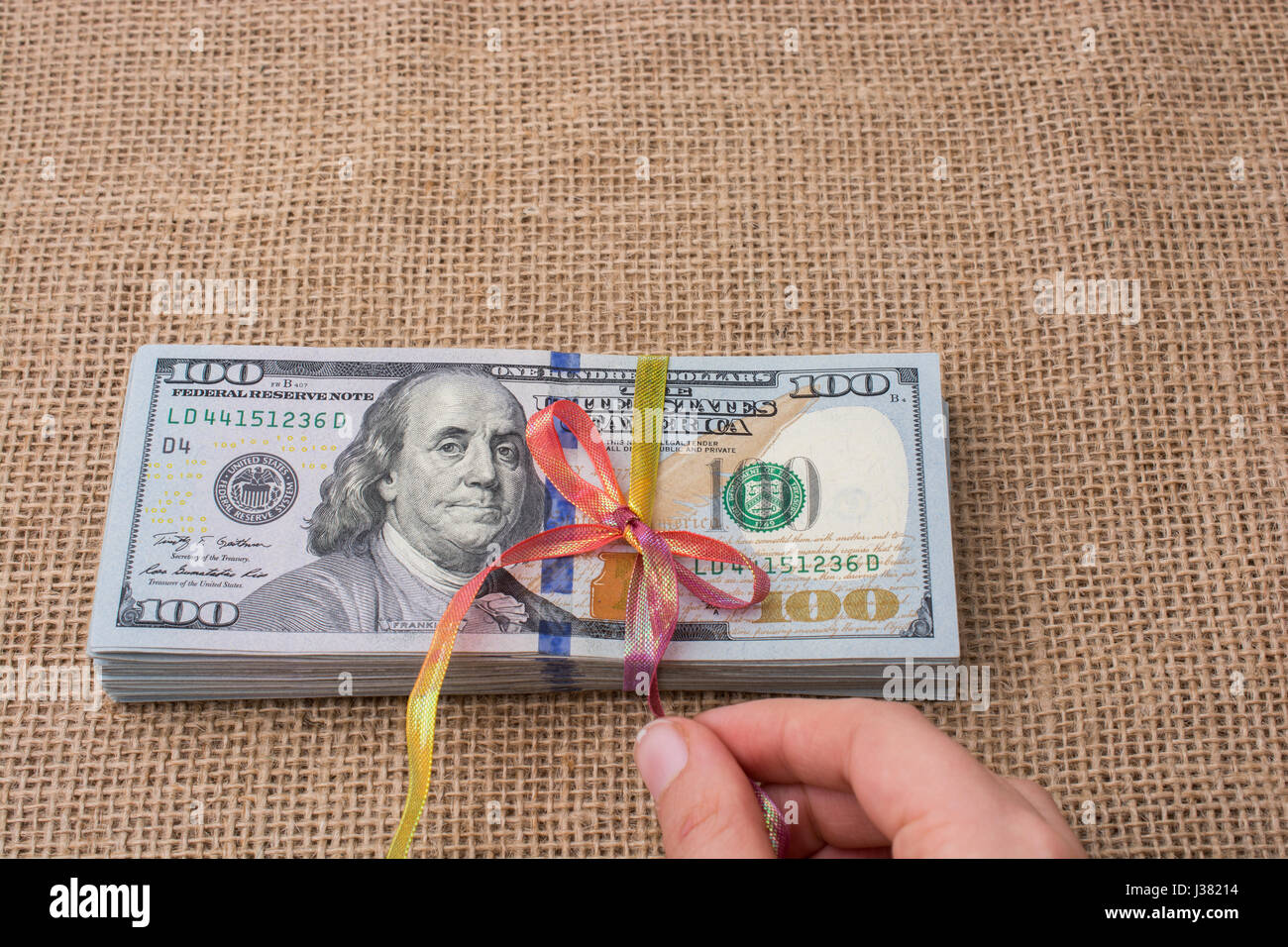 Banknote bundle of US dollar tied with colorful a ribbon Stock Photo ...