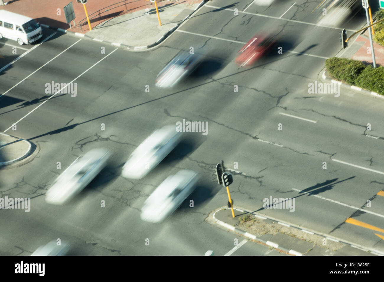 High angle view of blurred cars on road intersection during sunny day ...