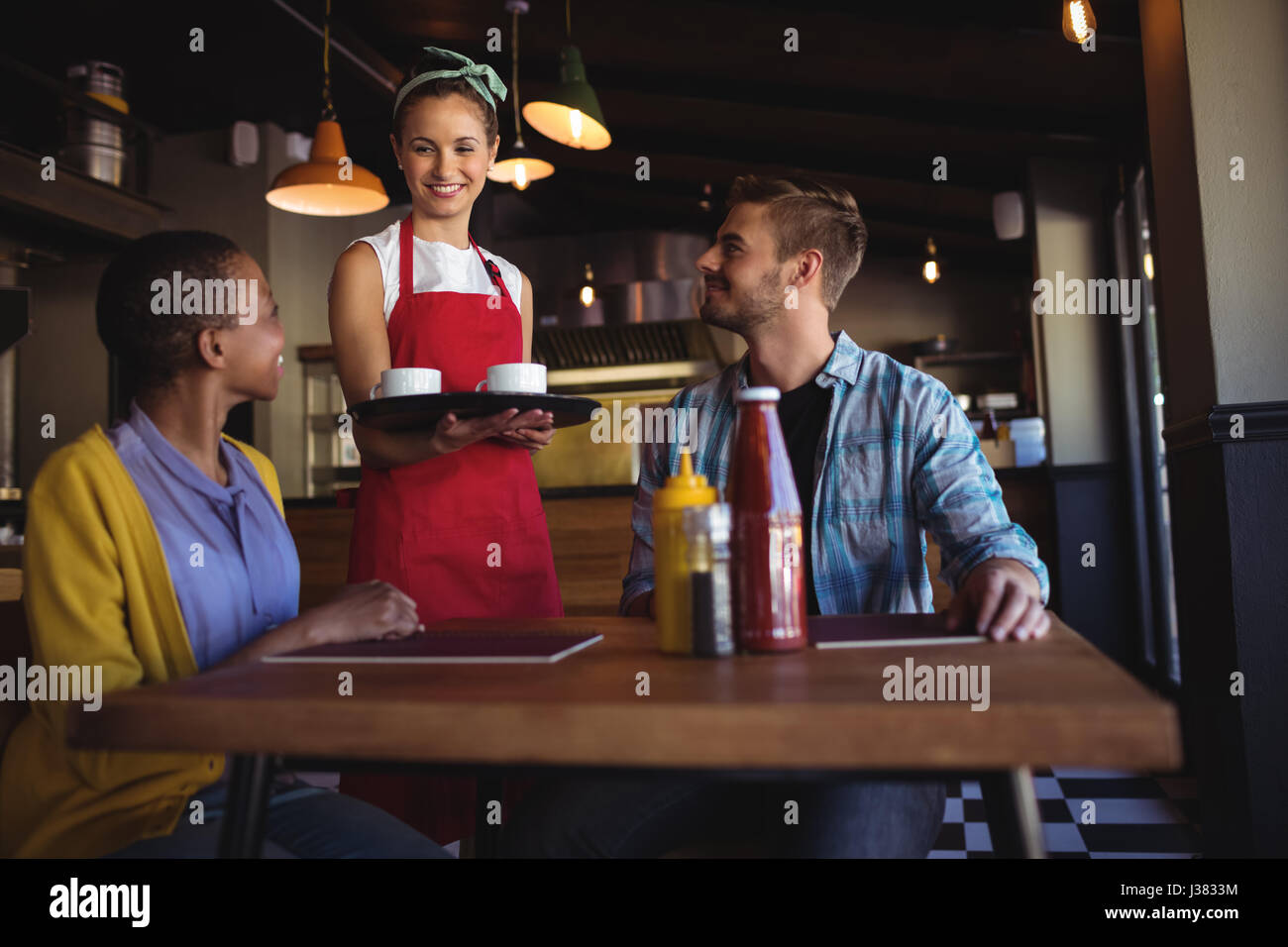 Waitress interacting with customer at restaurant Stock Photo - Alamy