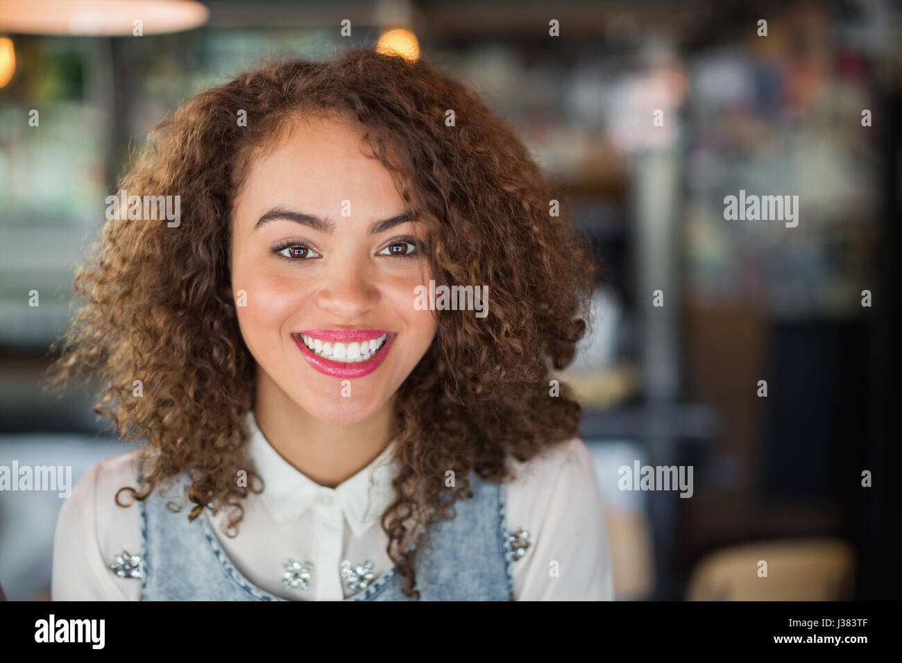 Portrait of happy beautiful woman in pub Stock Photo - Alamy