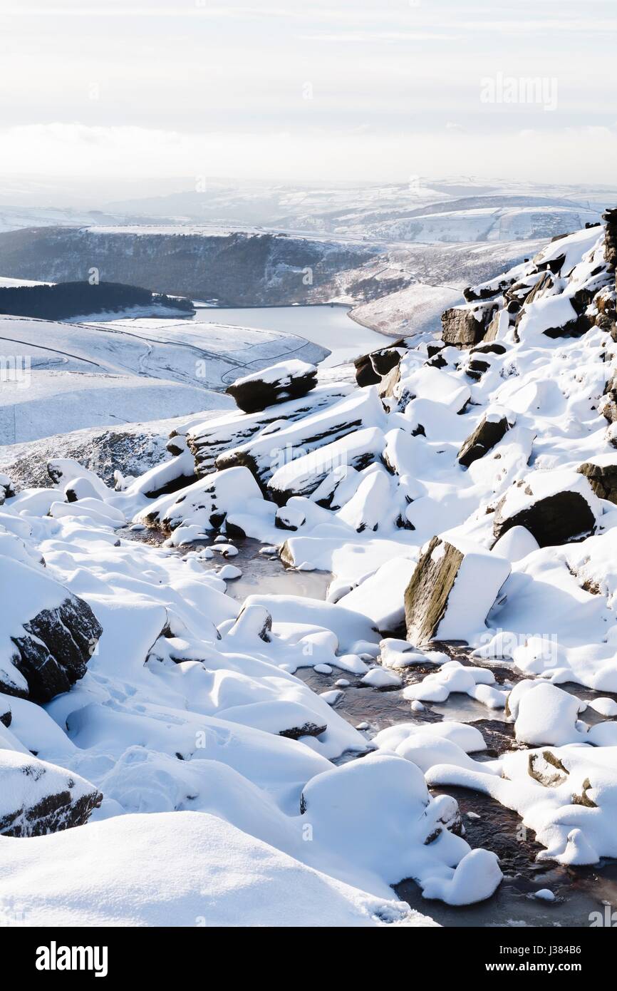 Snow covered countryside in winter with Kinder Reservoir viewed from ...