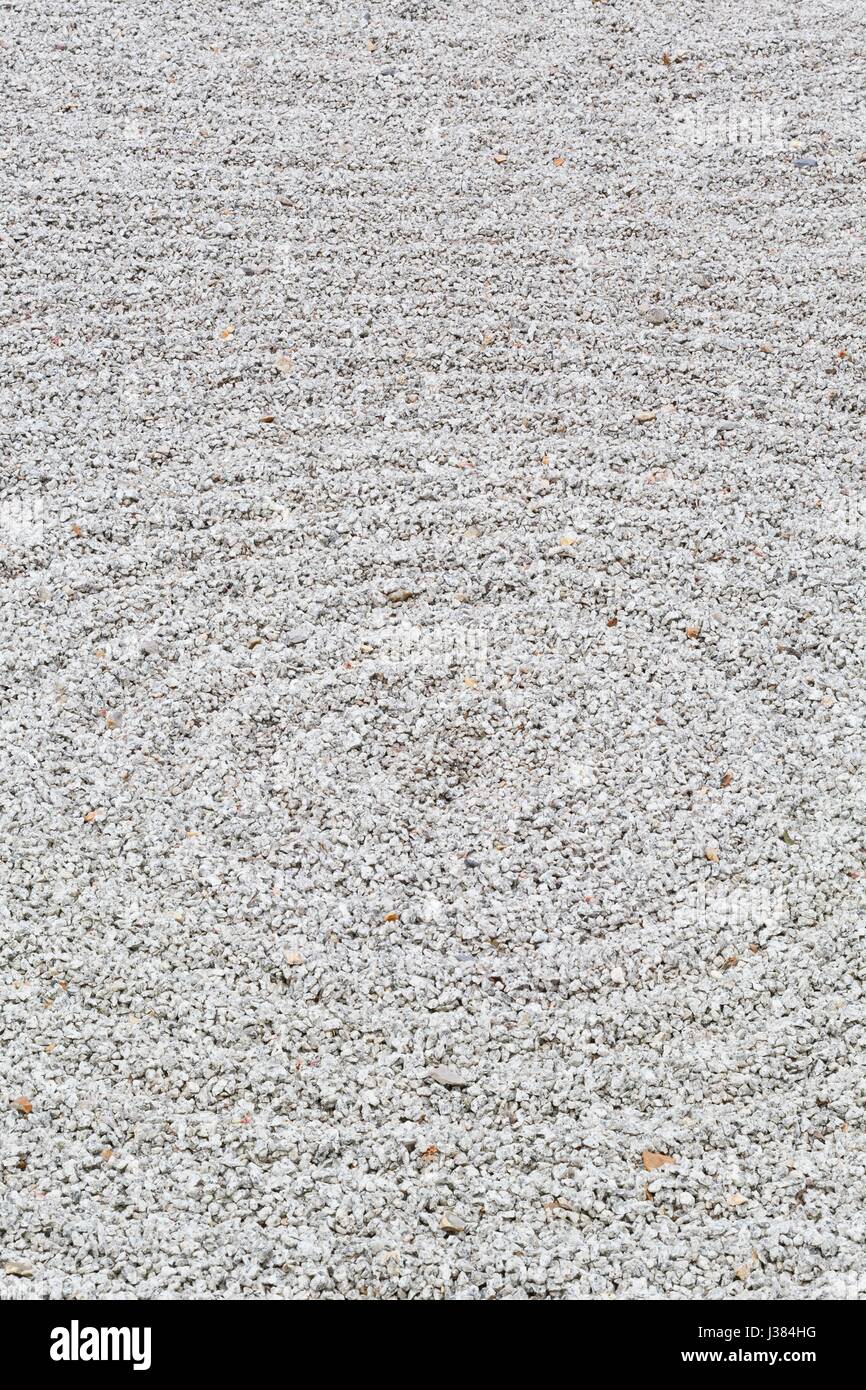 Circular raked gravel pattern in a zen garden Stock Photo - Alamy