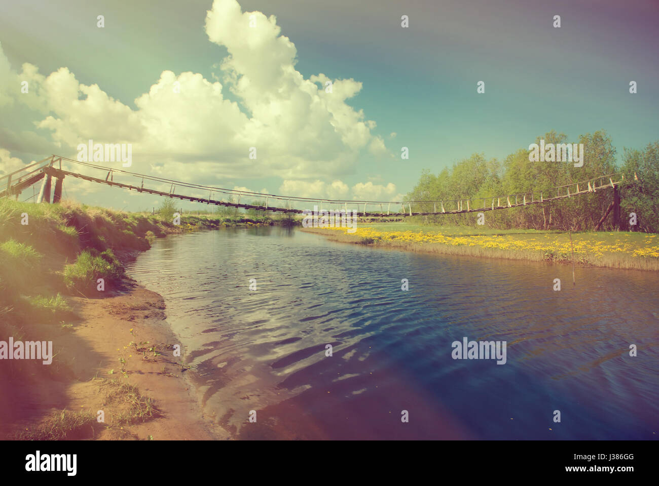 Suspension bridge over the river.Old Style Suspension Bridge ...