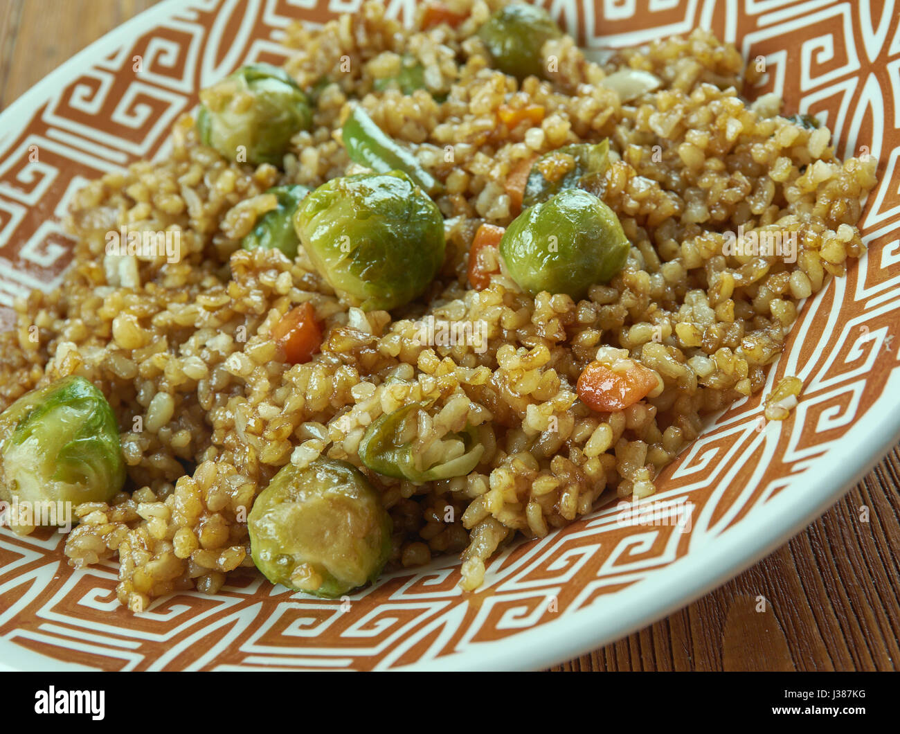 Freekeh - cereal food made from green durum wheat,Fried with vegetables ...