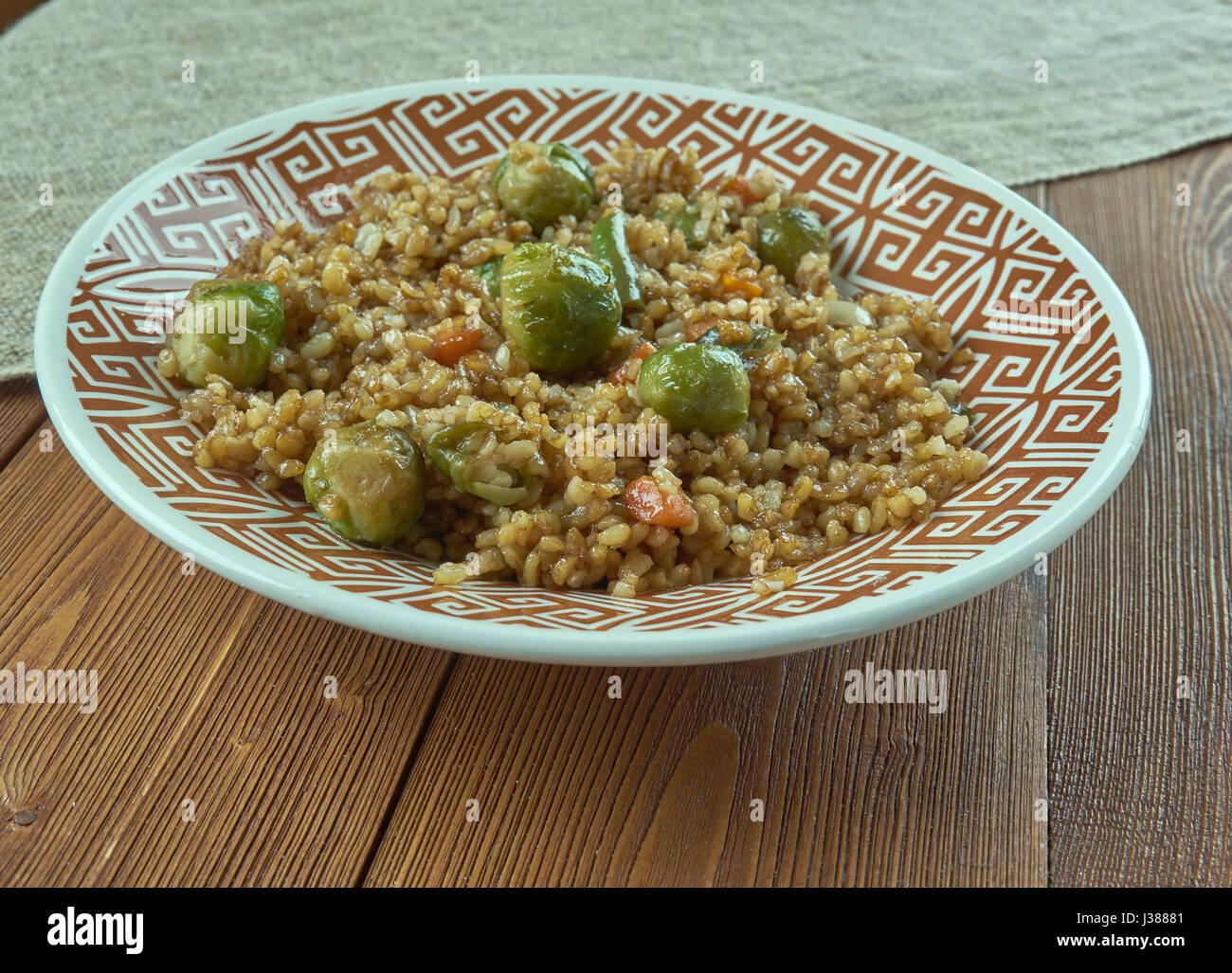 Freekeh - cereal food made from green durum wheat,Fried with vegetables ...