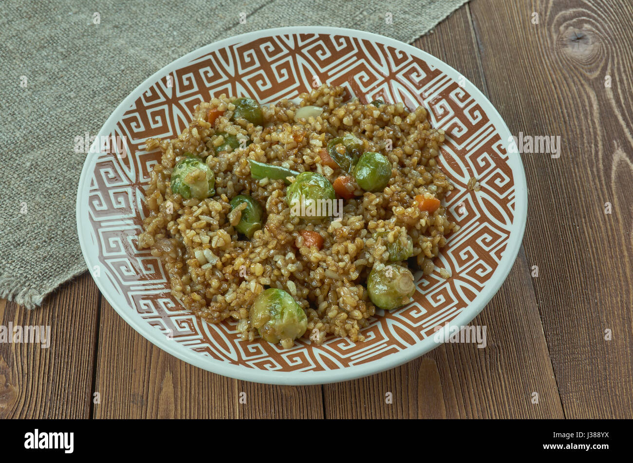 Freekeh - cereal food made from green durum wheat,Fried with vegetables ...