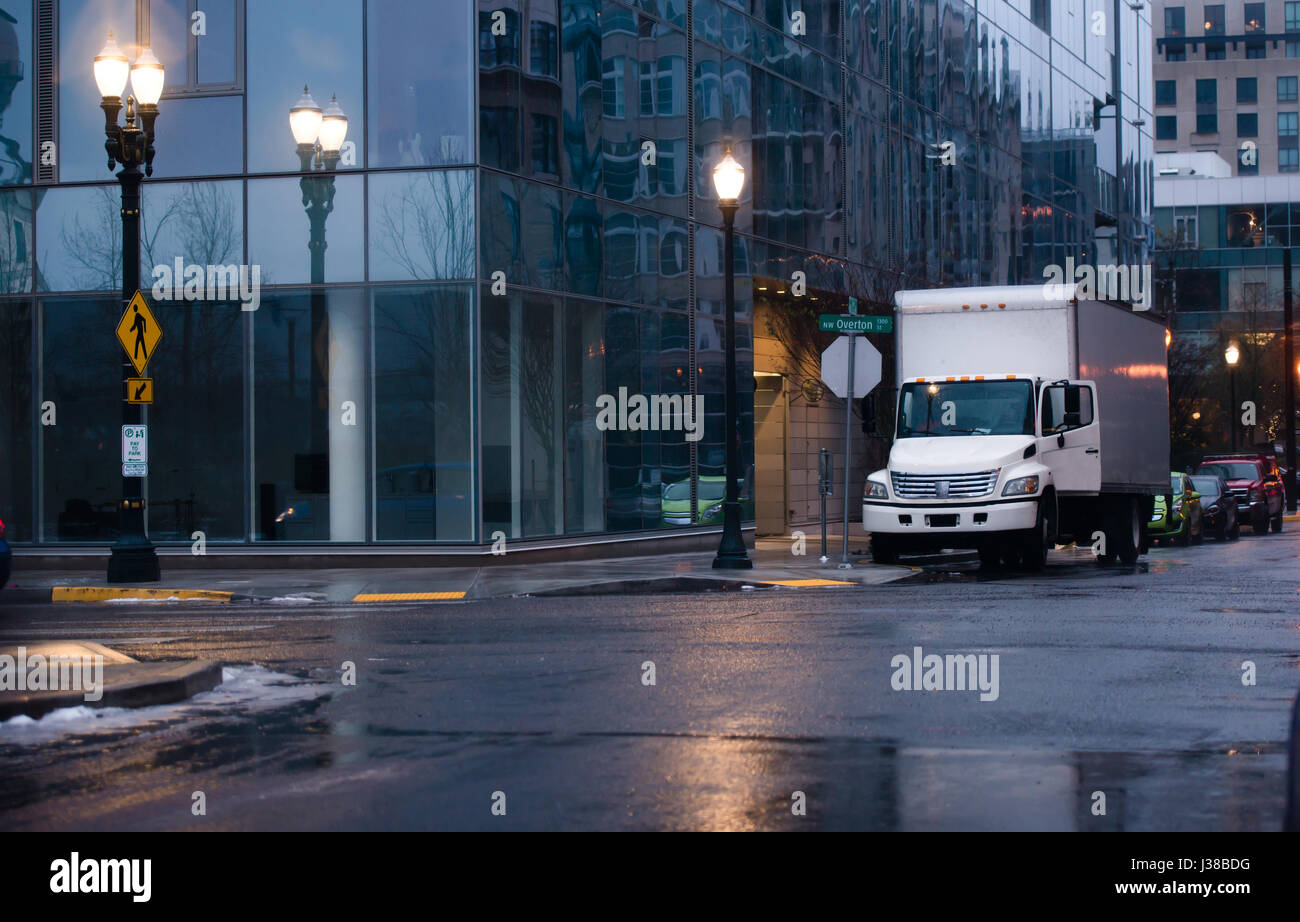 White compact small semi truck with a box trailer for local delivery of ...