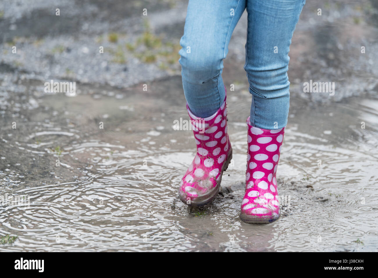 Child splash puddles boots hi-res stock photography and images - Alamy