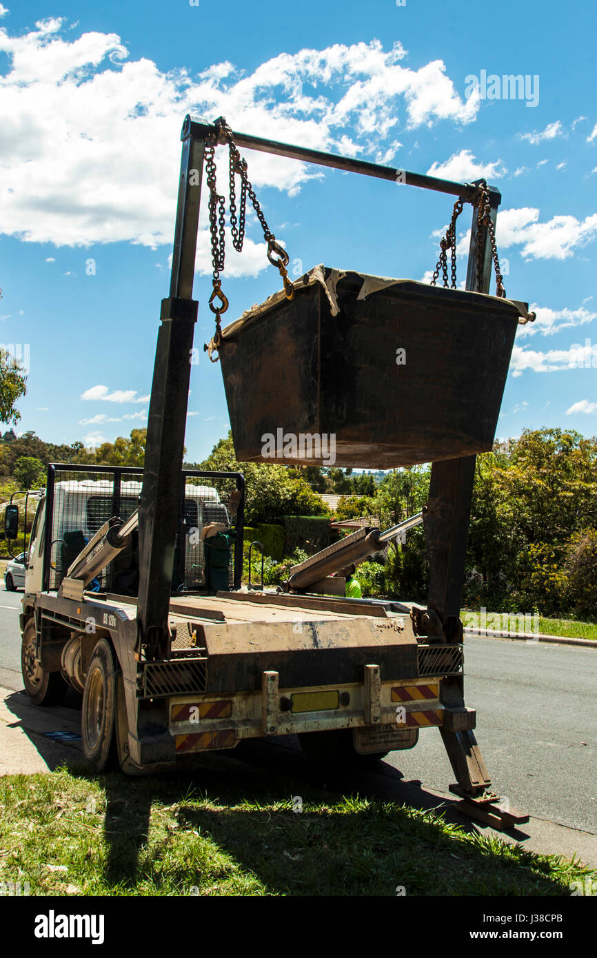 Truck loading garbage skip Stock Photo - Alamy