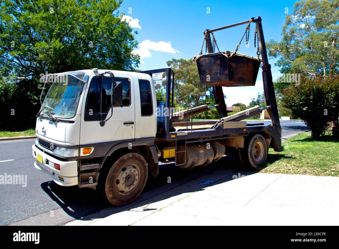 Truck loading garbage skip Stock Photo - Alamy