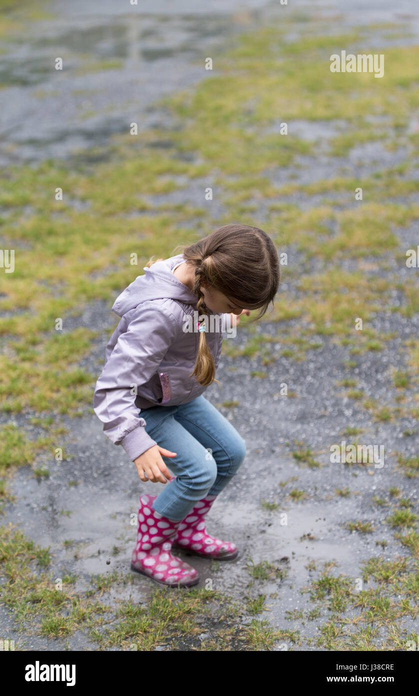 Girl jumping in the puddle Stock Photo - Alamy