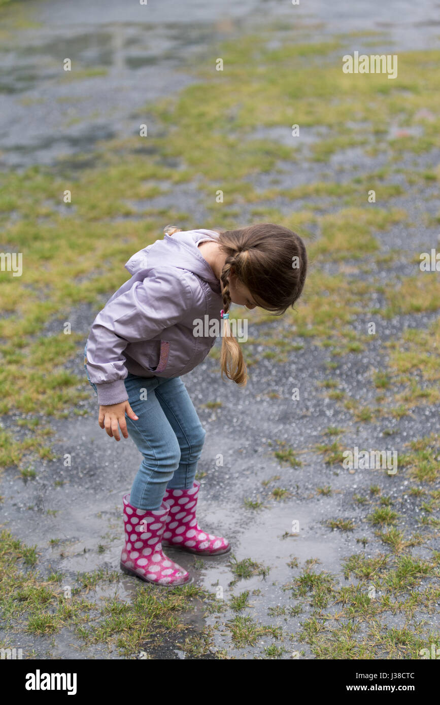 Girl splashing puddle hi-res stock photography and images - Alamy