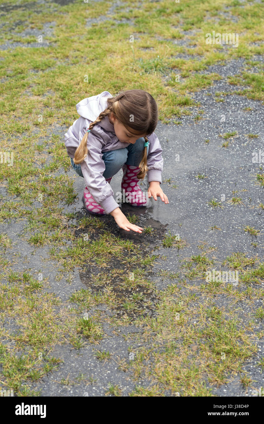 Child jumping in a puddle hi-res stock photography and images - Alamy