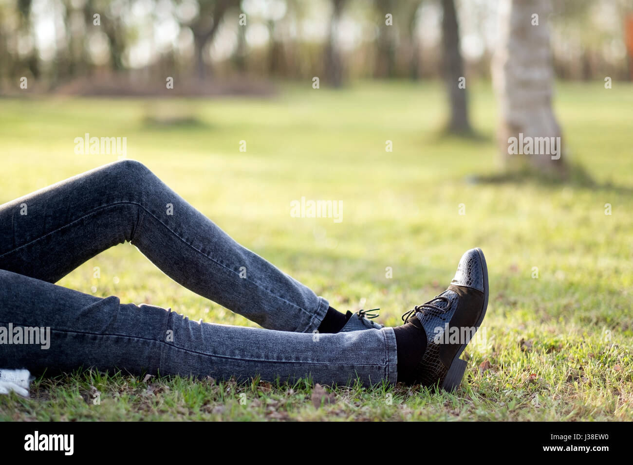 Relaxing woman legs in park Stock Photo - Alamy