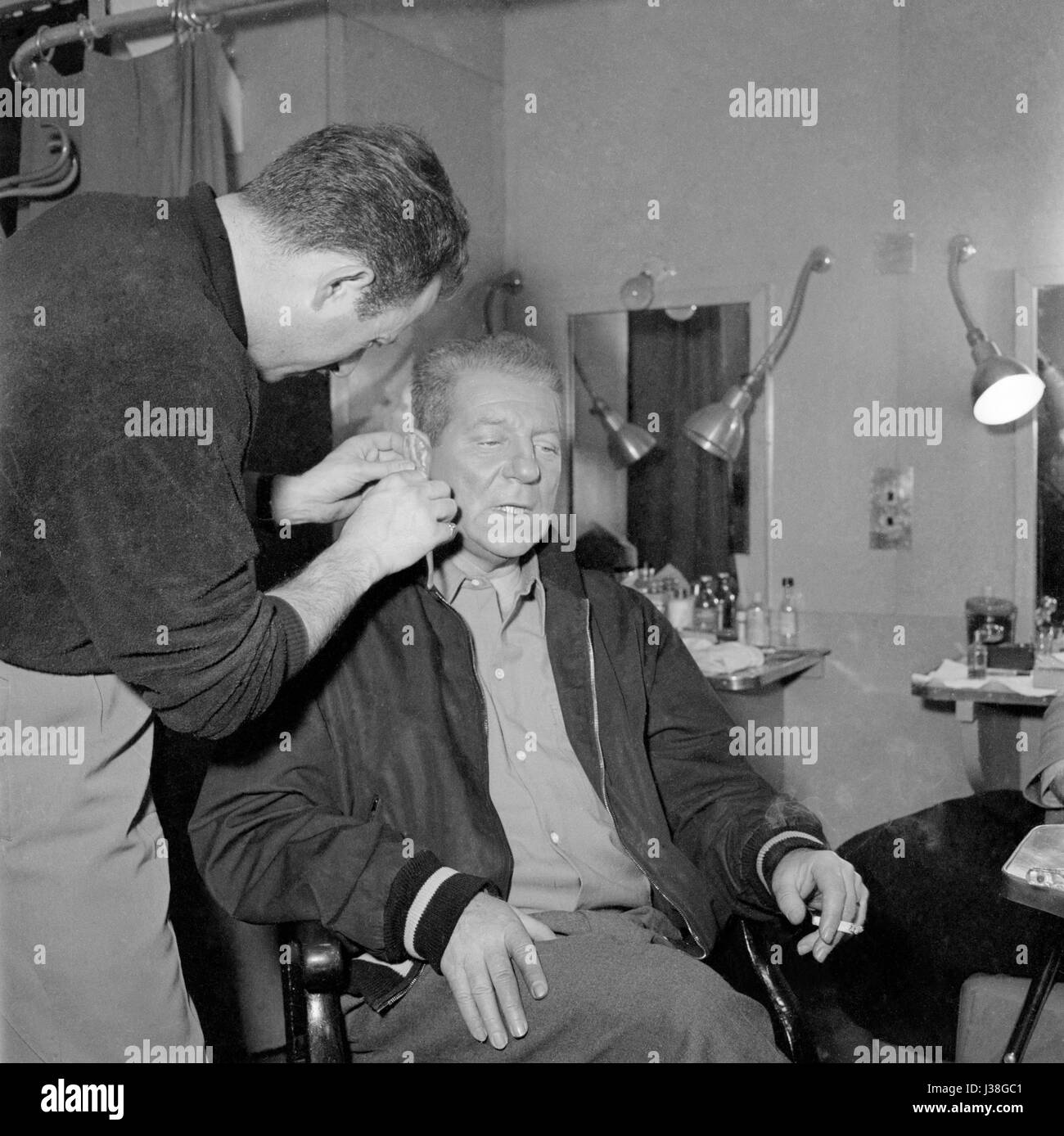 French actor Jean Gabin during a make-up session on the set of a film ...