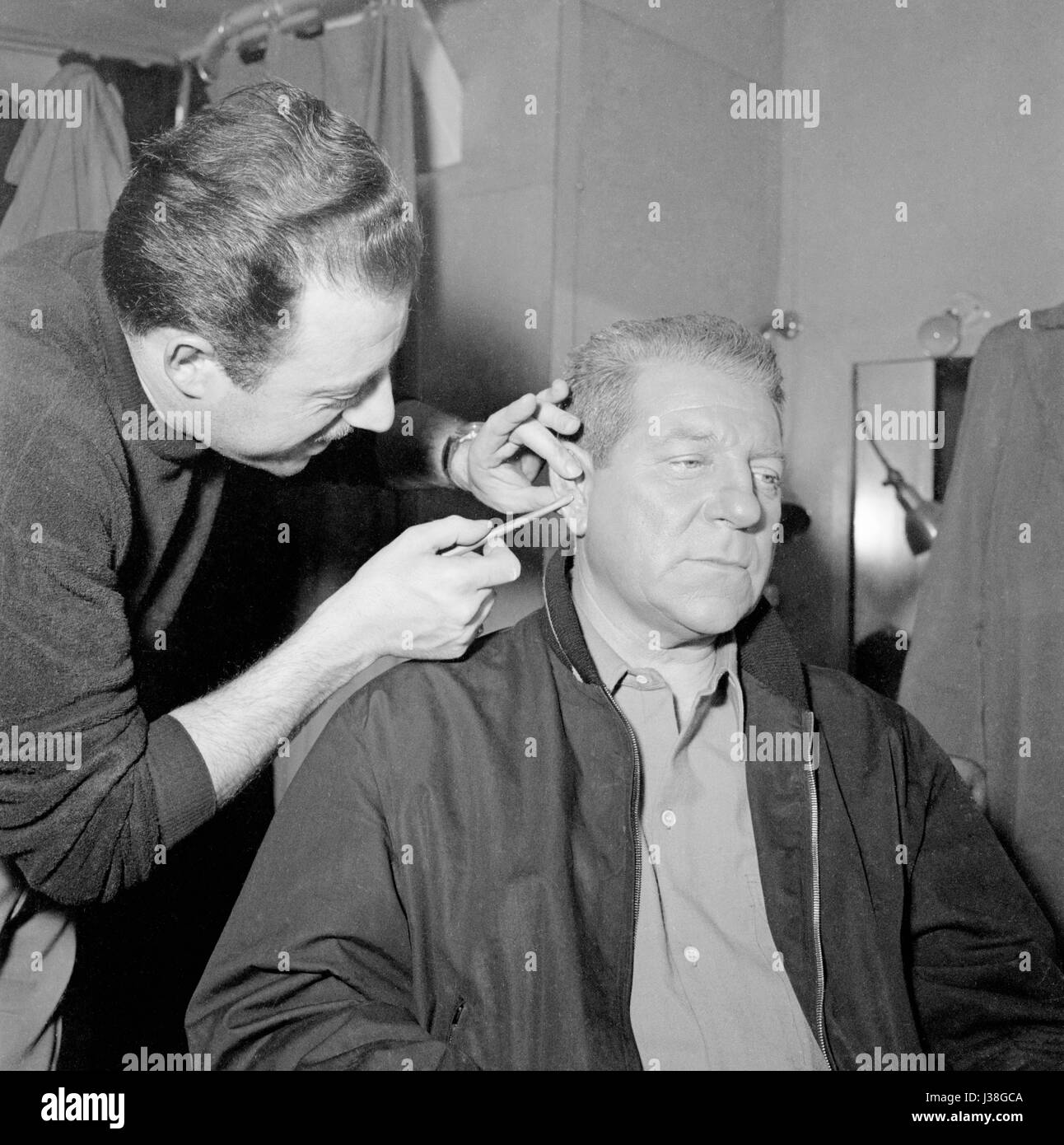 French actor Jean Gabin during a make-up session on the set of a film ...