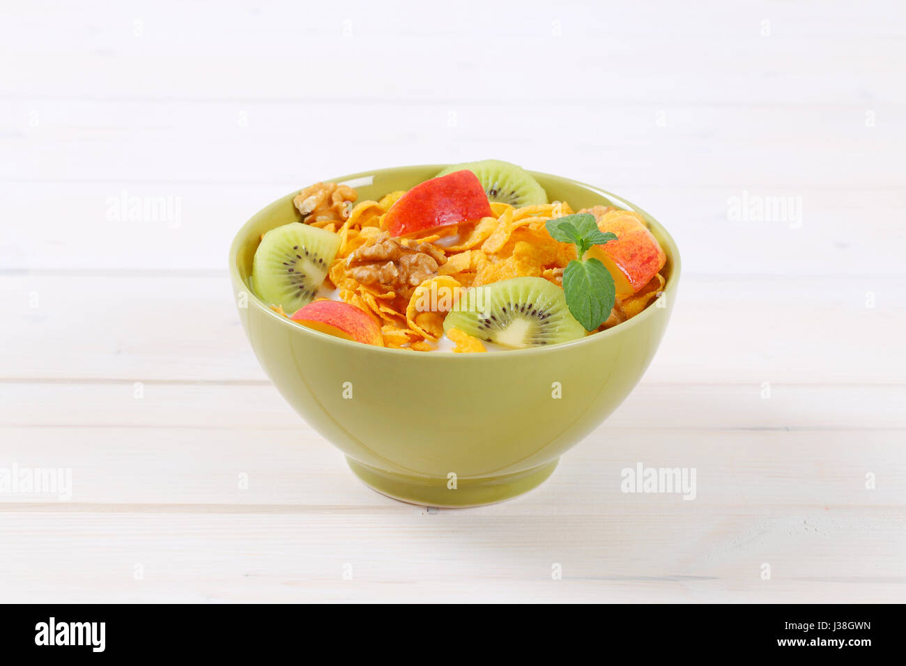 bowl of corn flakes with milk and fresh fruit on white background Stock ...