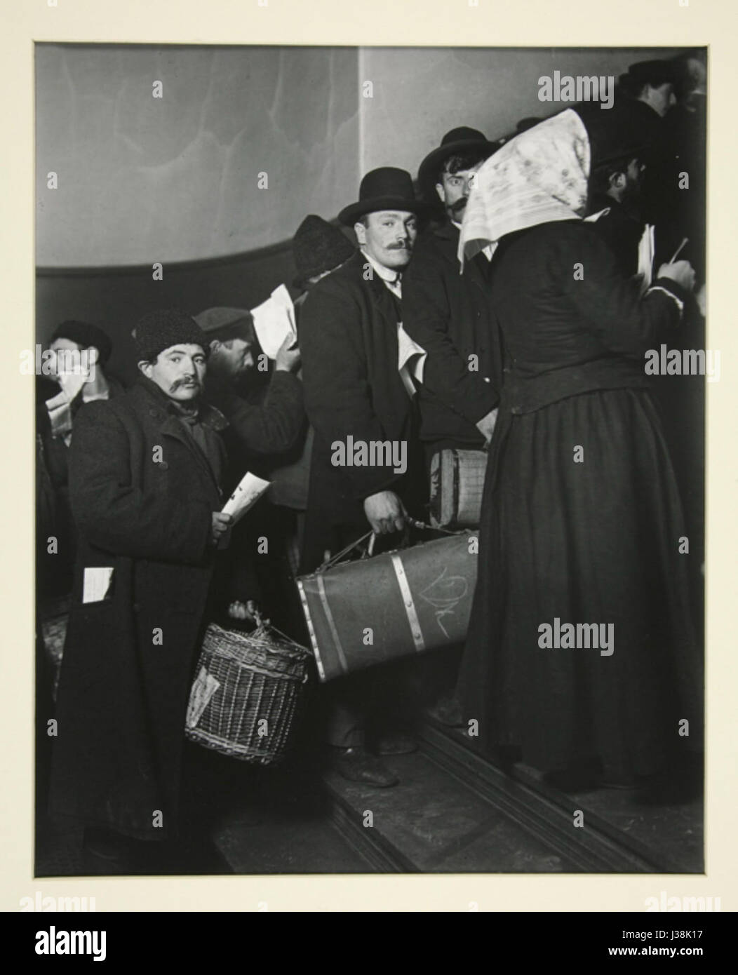 This photograph, taken by Lewis Hine, shows immigrants arriving at ...