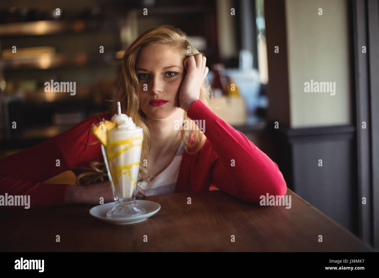 Portrait of beautiful woman having milkshake in restaurant Stock Photo ...