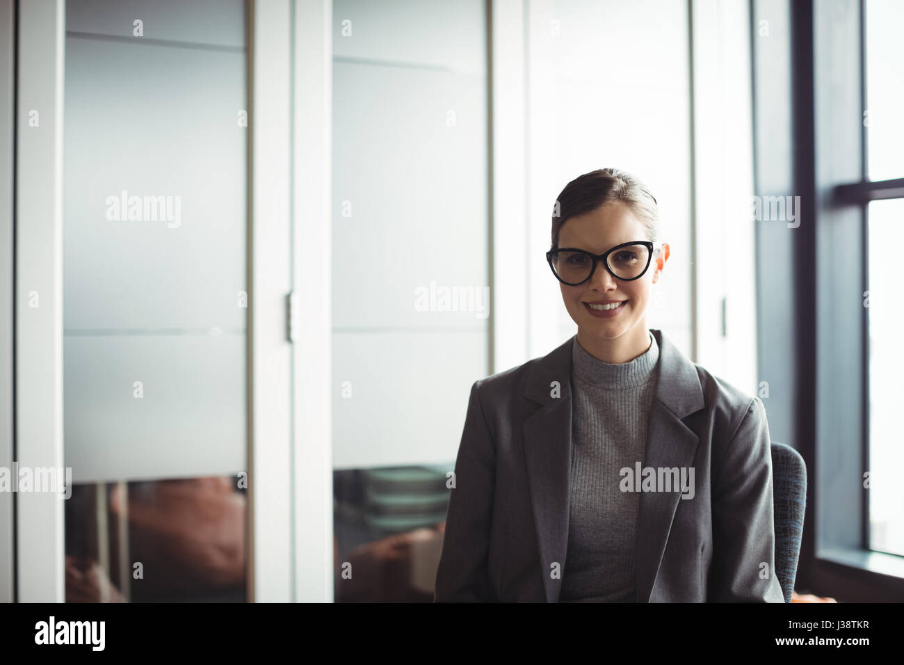 Portrait of smiling counselor in office Stock Photo - Alamy