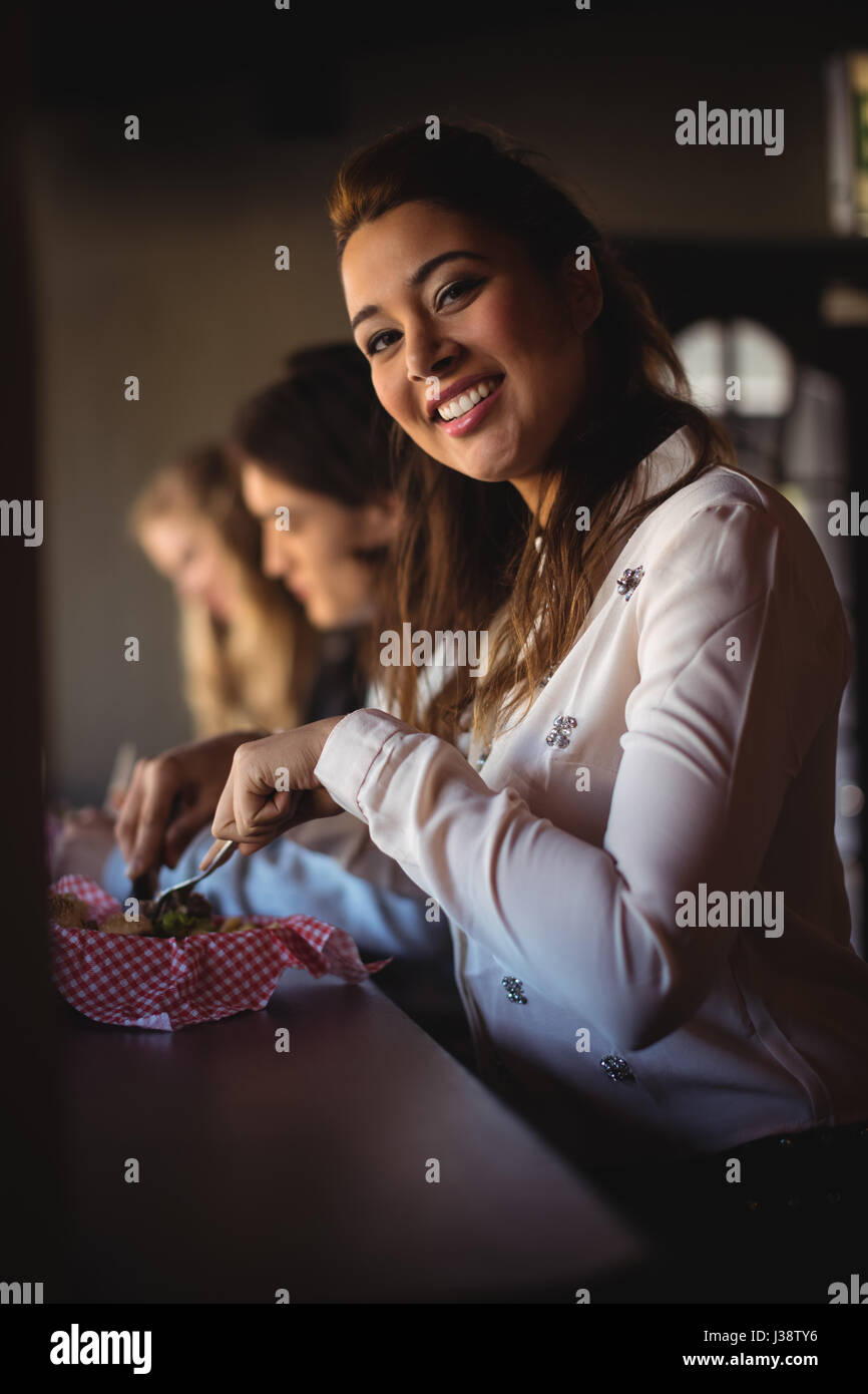 Friends having burger together at restaurant Stock Photo - Alamy
