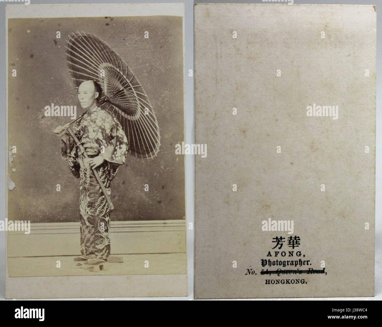 This photograph by Afong captures a Chinese man holding an umbrella ...