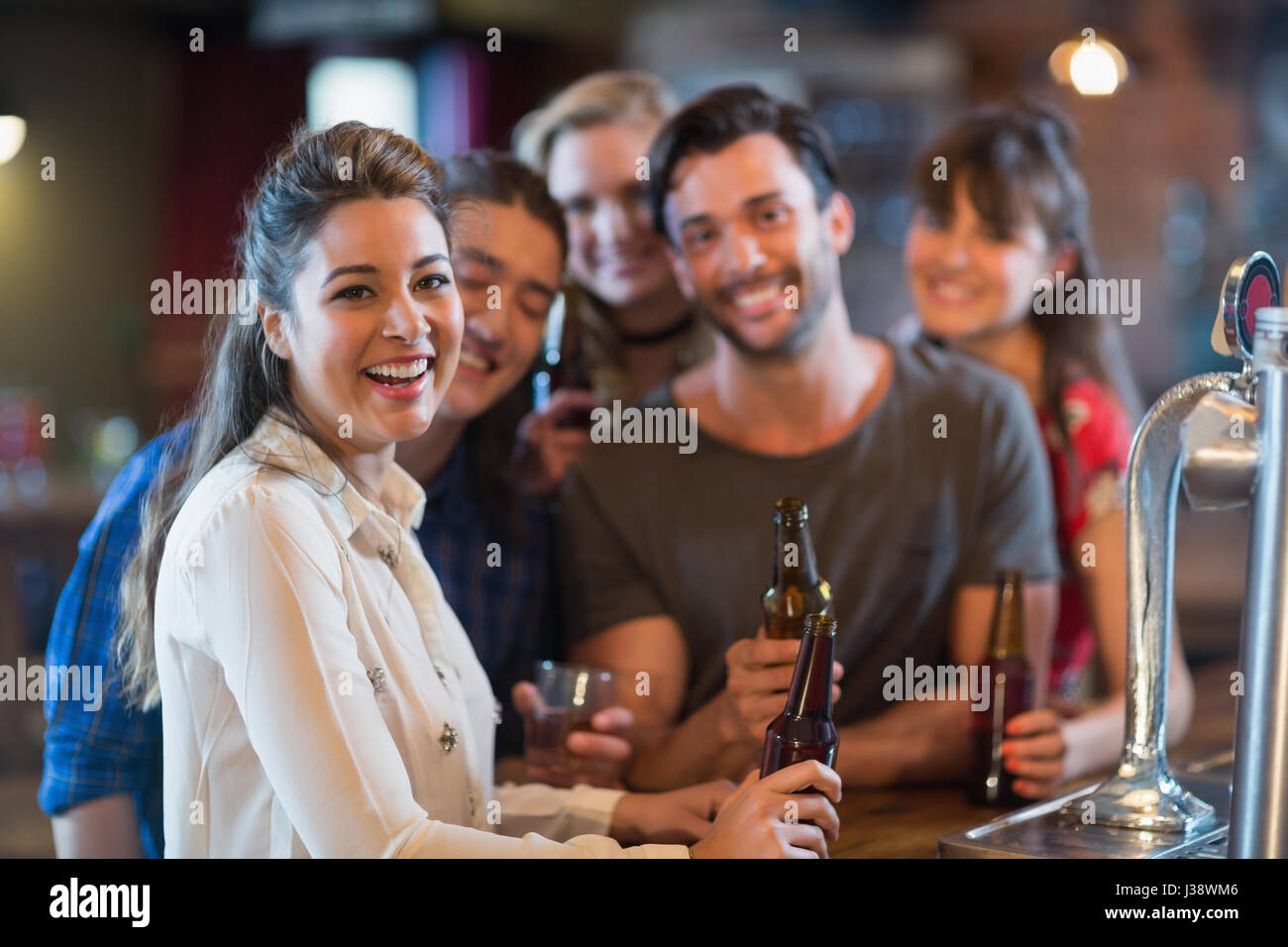 Portrait of cheerful friends in pub Stock Photo - Alamy