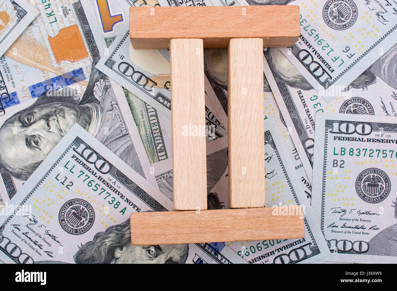 Wooden building blocks placed on spread US dollar Banknotes Stock Photo ...