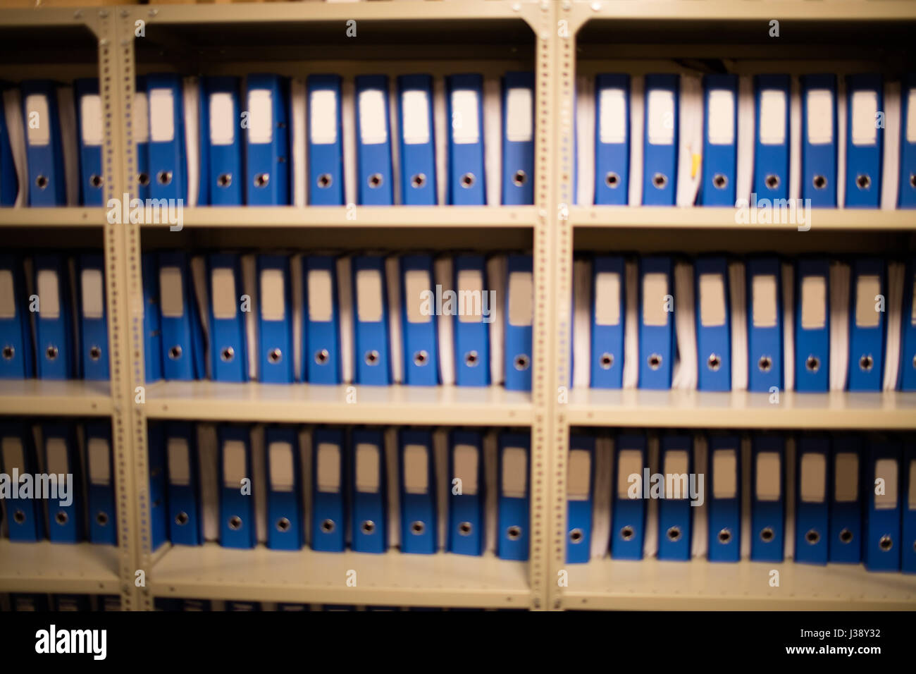 Blue files arranged on metallic cabinet Stock Photo - Alamy
