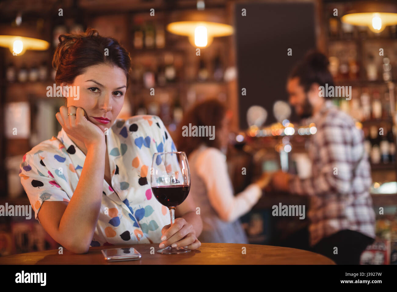 Upset woman ignoring affectionate couple in pub Stock Photo - Alamy
