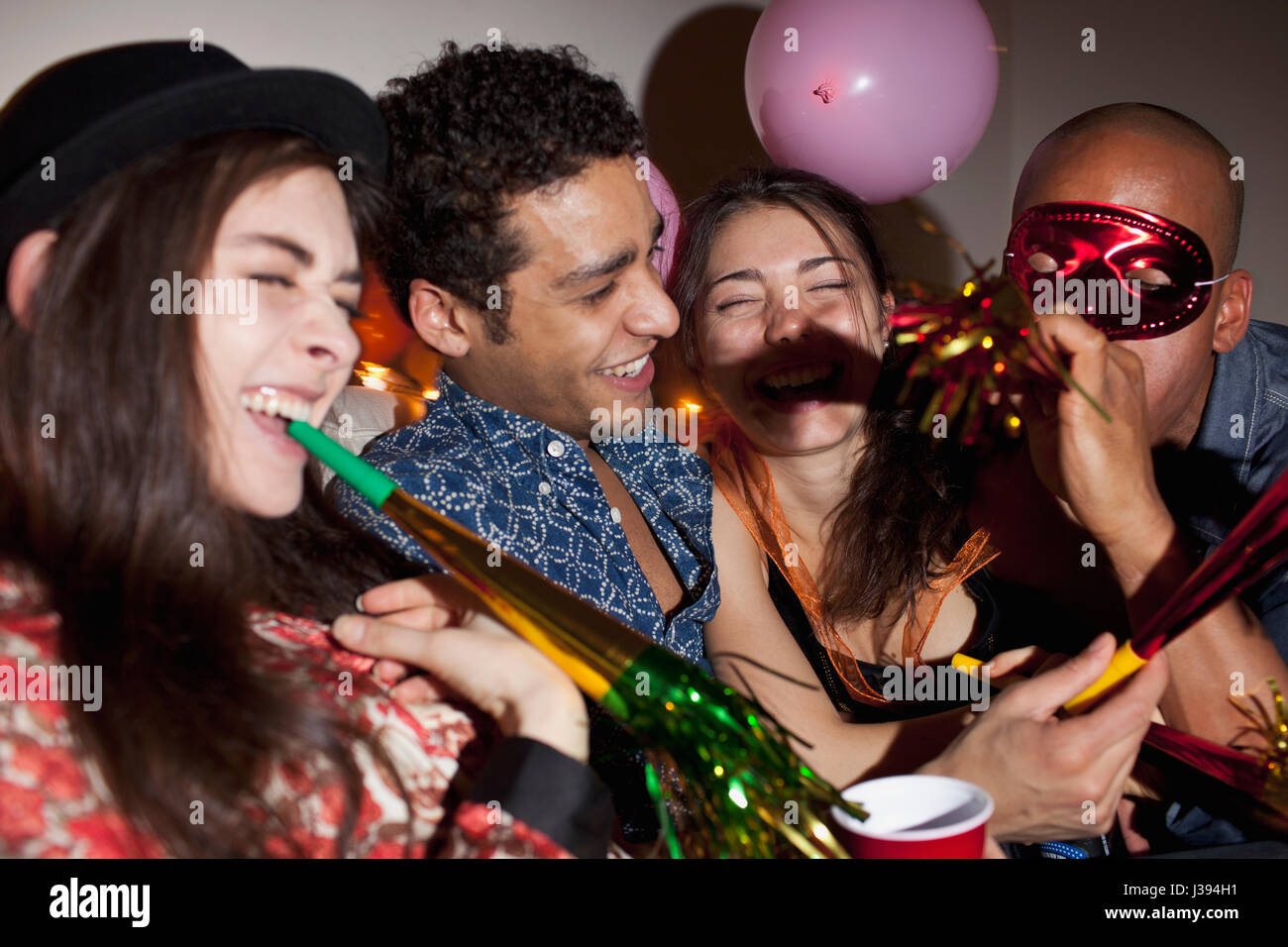 Friends hanging out at a party Stock Photo - Alamy