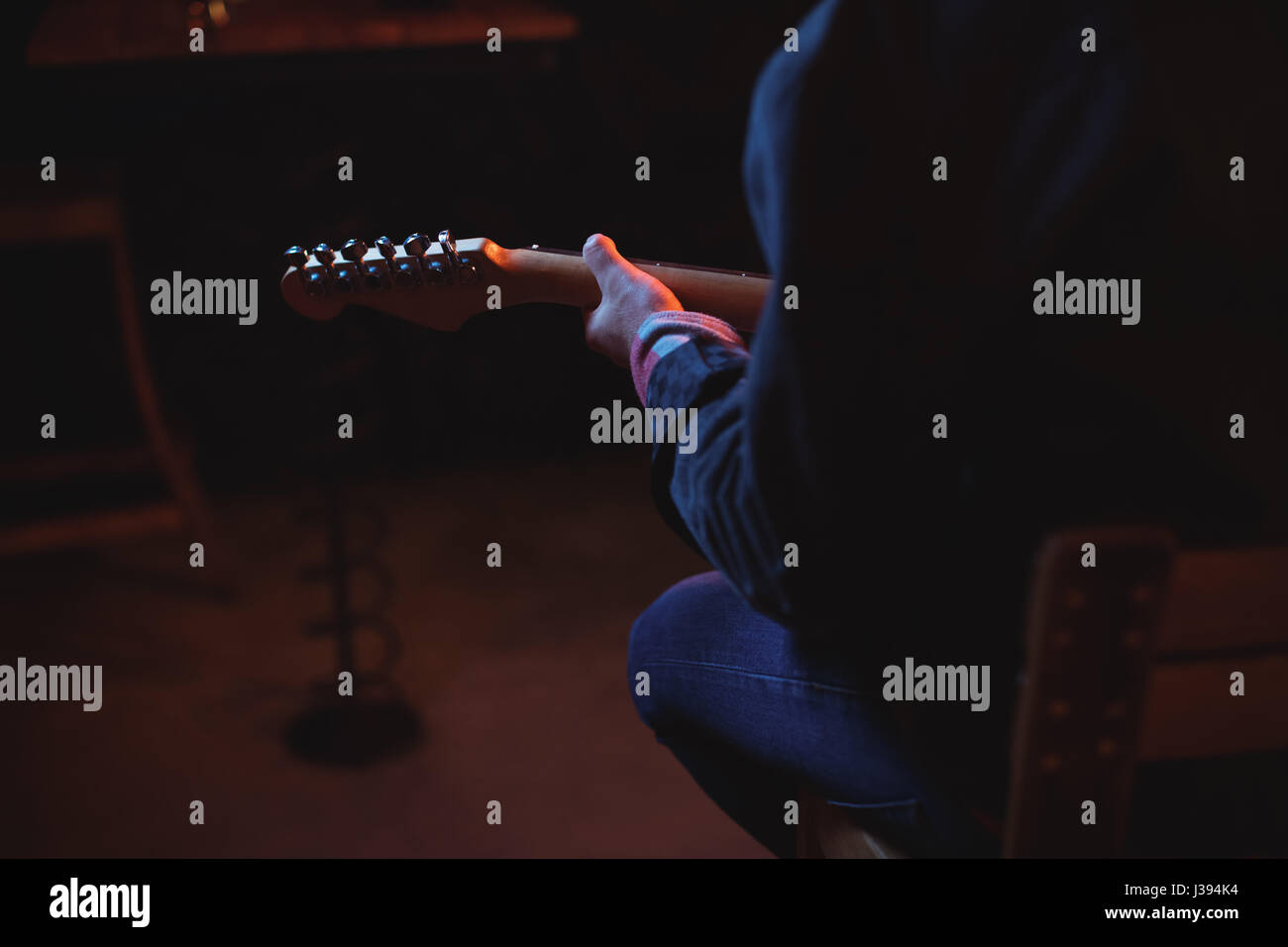 Mid-section of man playing guitar in pub Stock Photo - Alamy