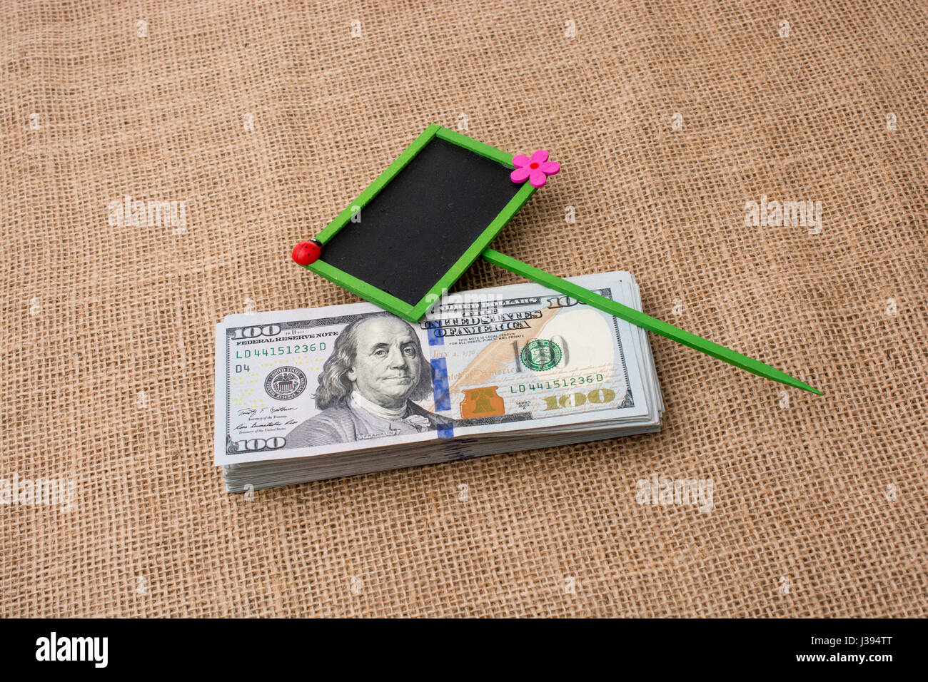 Notice board placed on the bundle of US dollar banknote Stock Photo - Alamy