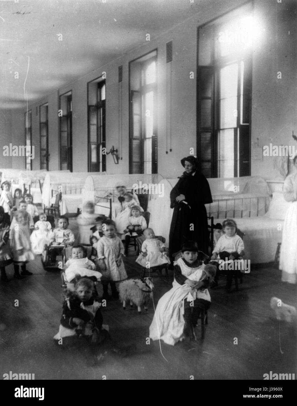 The image 'Children at New York Foundling' captures a moment at the New ...