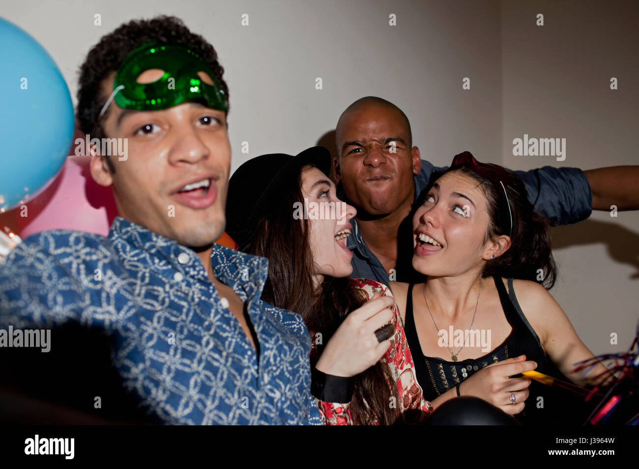Friends hanging out at a party Stock Photo - Alamy