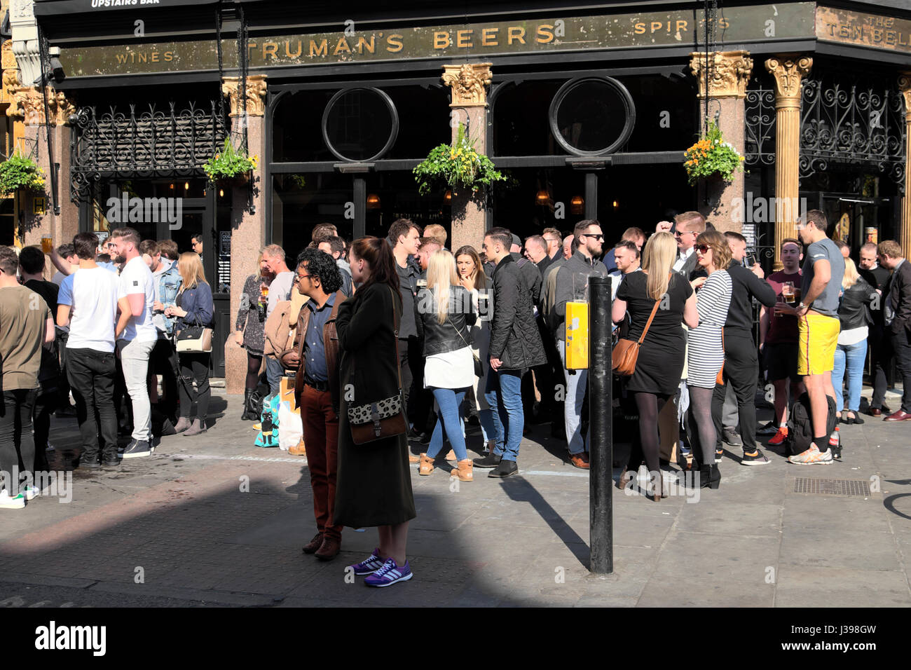A view of people outside the Ten Bells pub on Commercial Street in ...