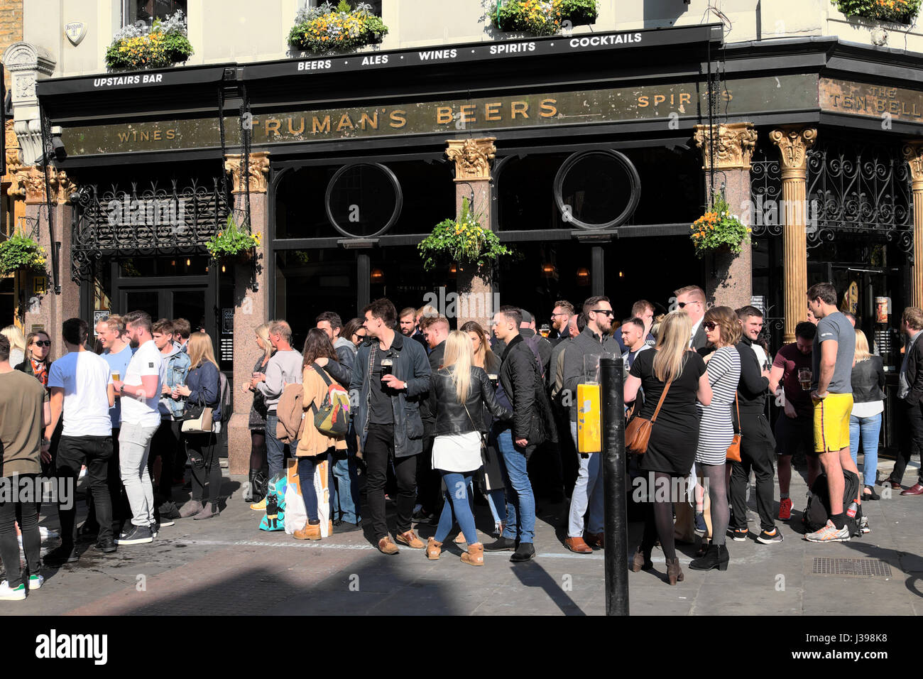 A view of people outside the Ten Bells pub on Commercial Street in ...