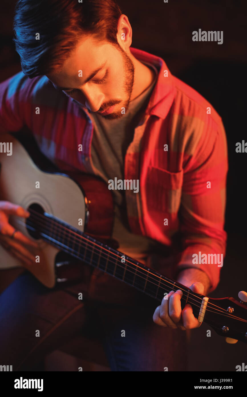 Young man playing guitar in pub Stock Photo - Alamy