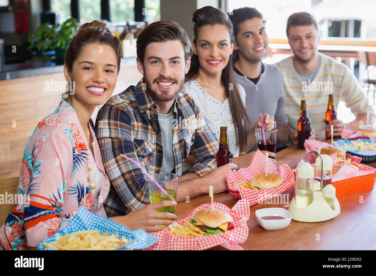 Woman waving at table of friends hi-res stock photography and images ...