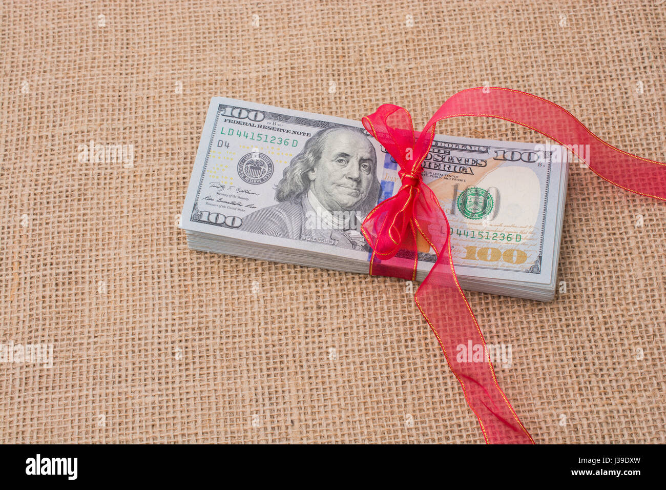 Banknote bundle of US dollar tied with colorful a ribbon Stock Photo ...