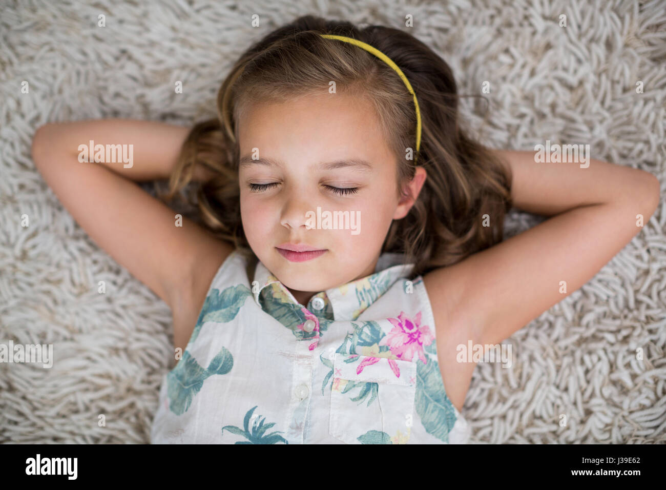 Girl sleeping on rug in living room at home Stock Photo - Alamy