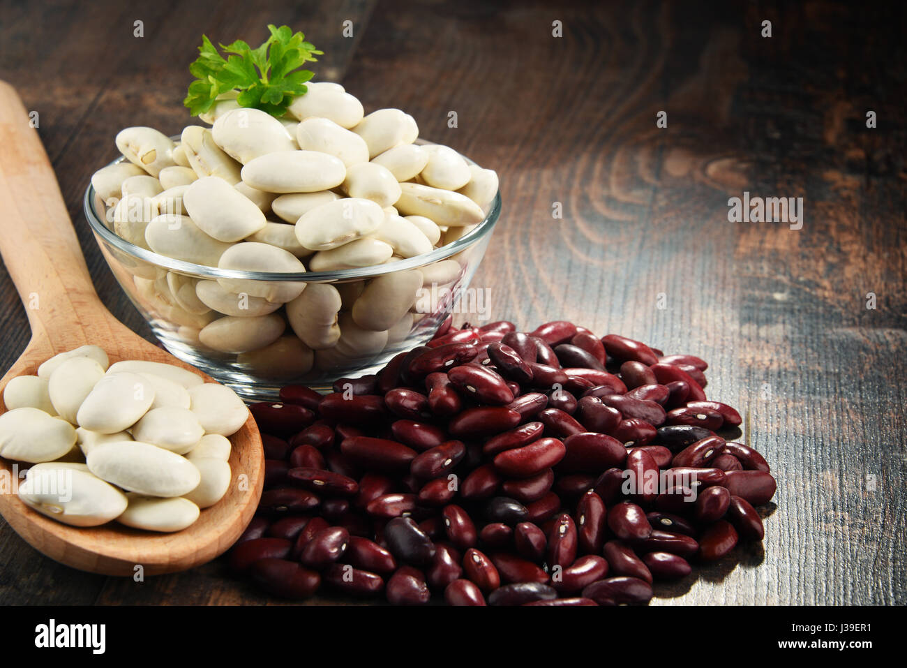 Composition with bowl of beans on wooden table Stock Photo - Alamy