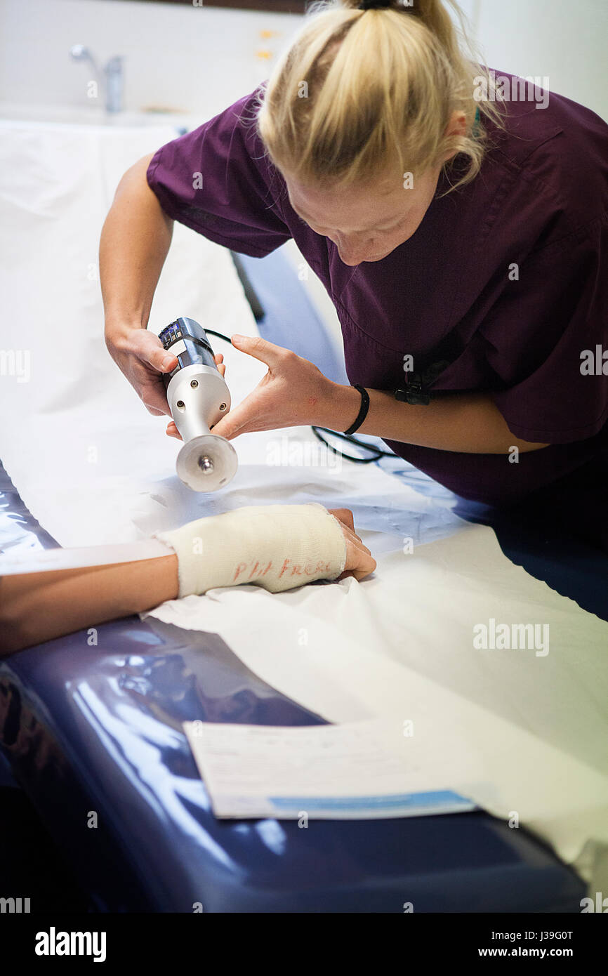 Doctor removing plaster cast hi-res stock photography and images - Alamy