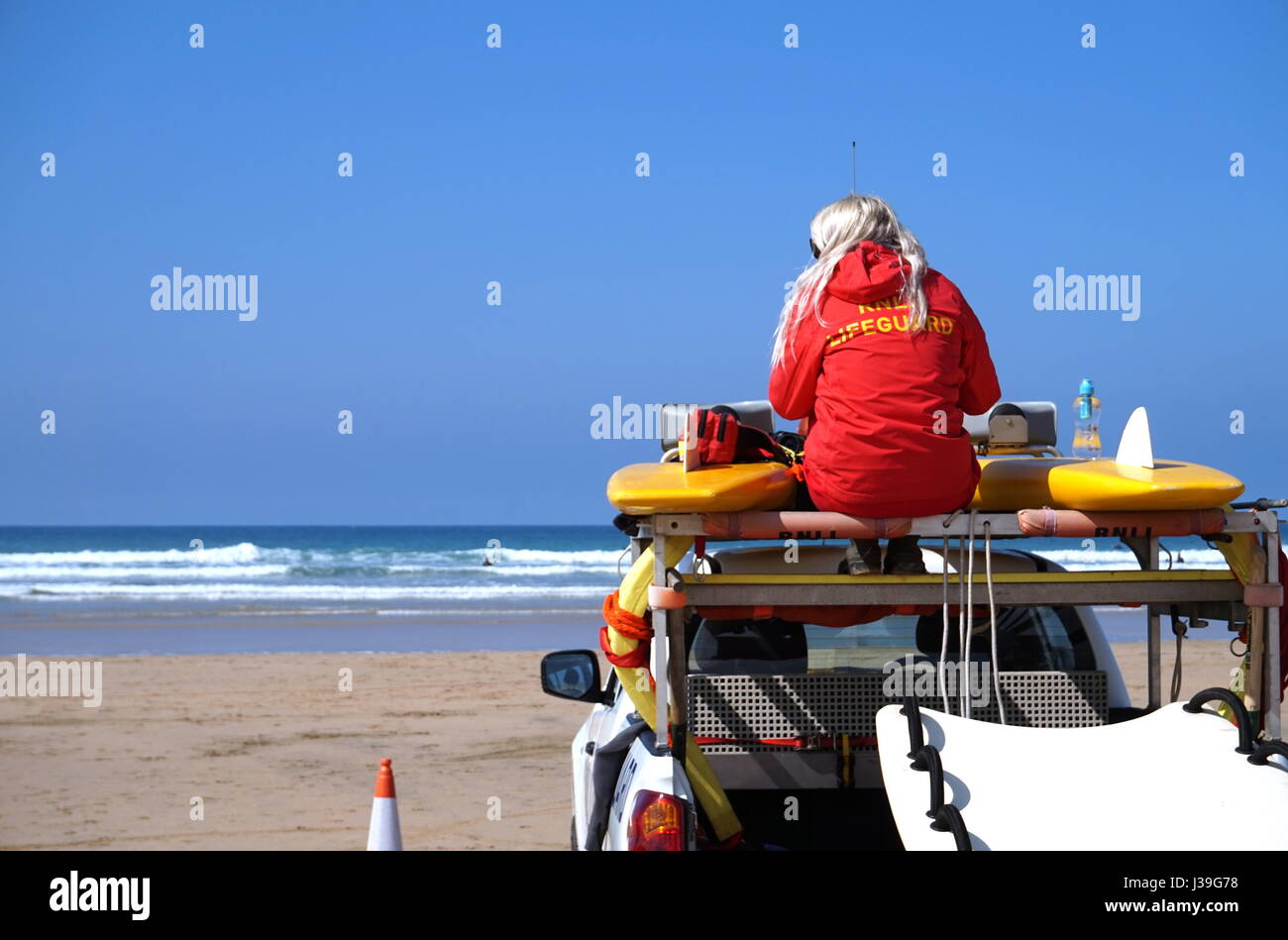 Newquay, Cornwall, UK - April 7 2017: Female RNLI lifeguard keeping ...