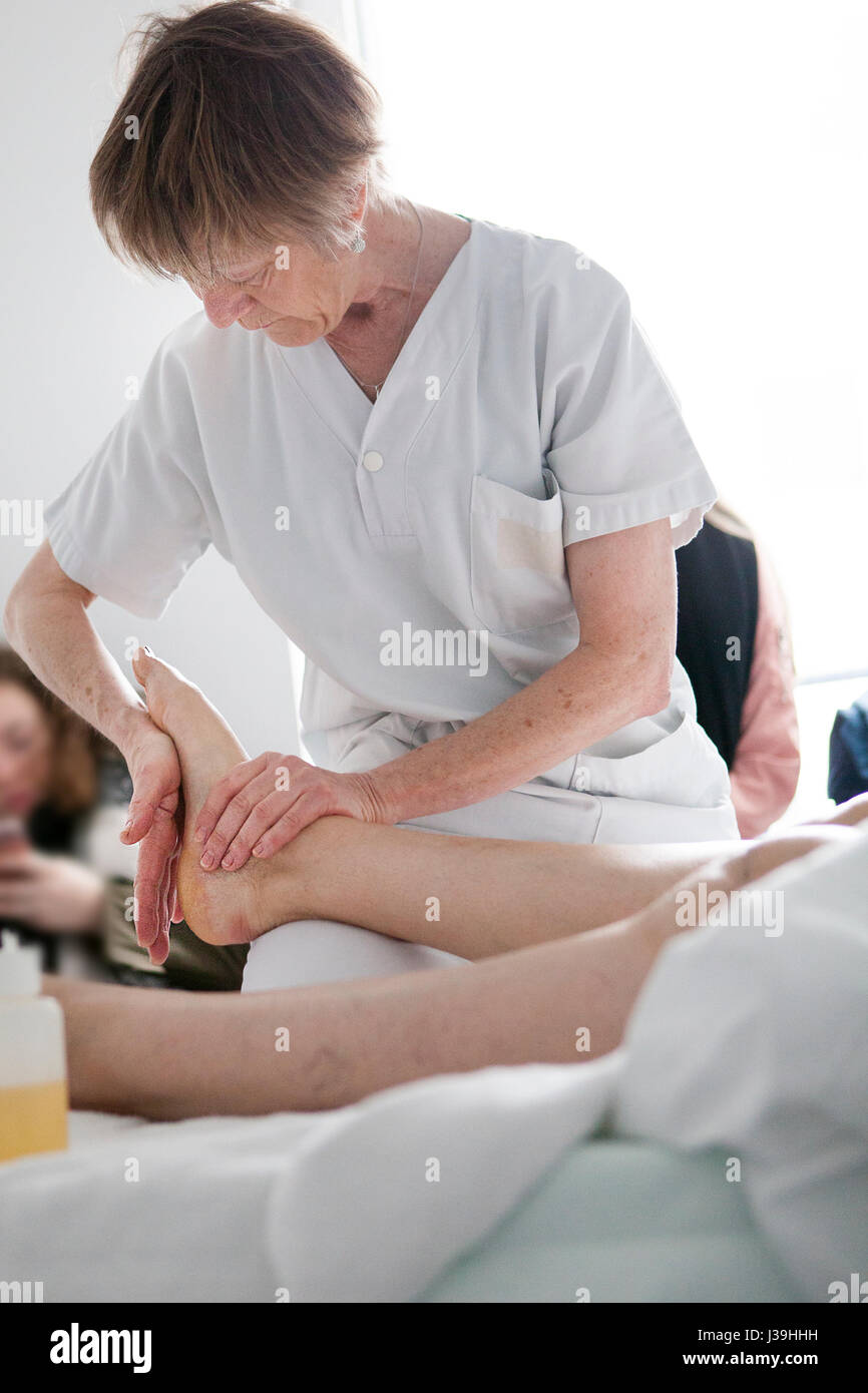 Woman touch foot hi-res stock photography and images - Alamy